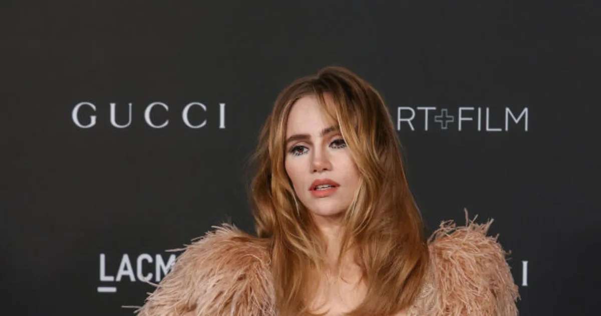 Suki Waterhouse in lingerie - she only wears a coat over it